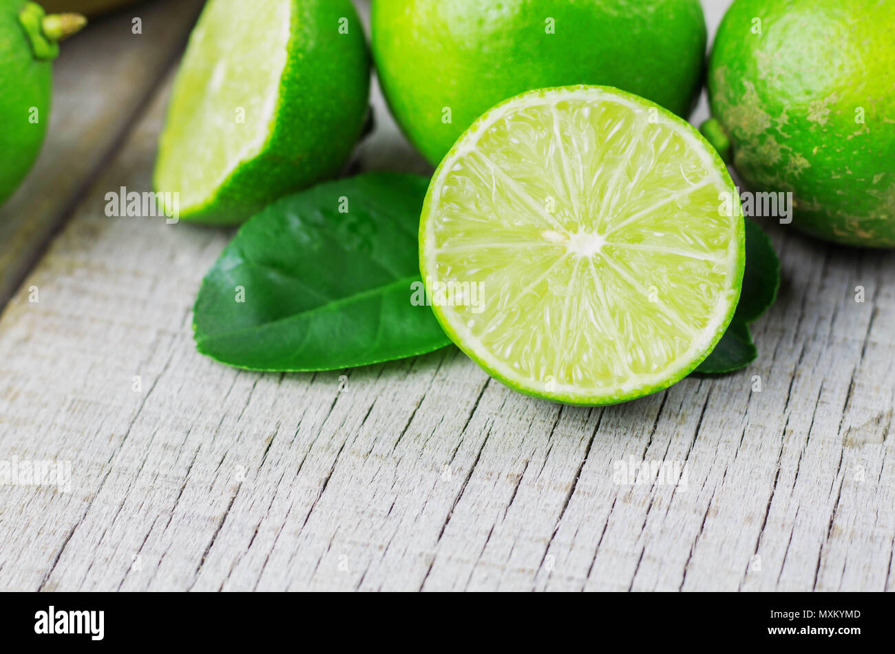 Lime half cut on the old wooden floor Stock Photo - Alamy