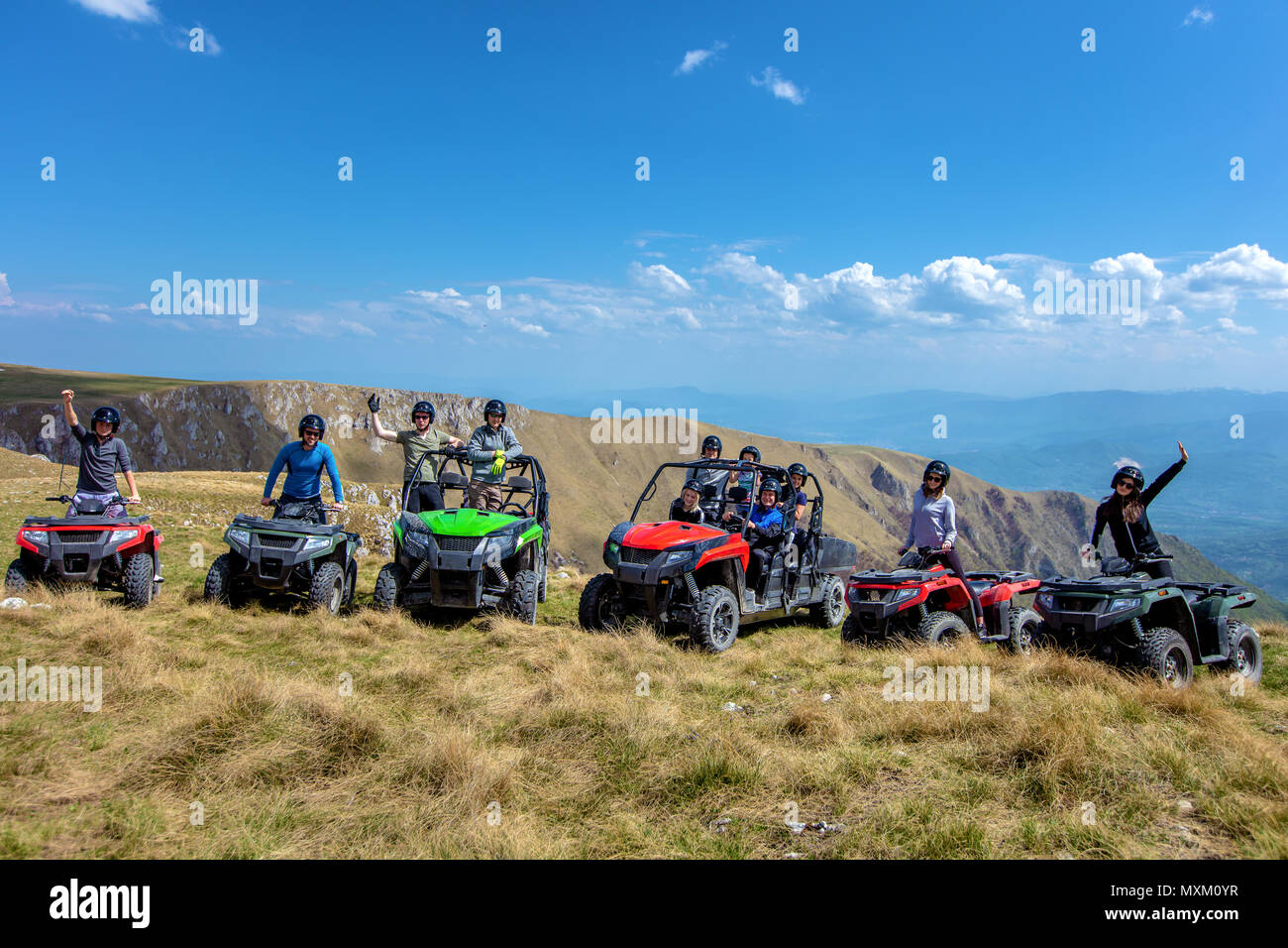 Friends driving off-road with quad bike or ATV and UTV vehicles Stock ...
