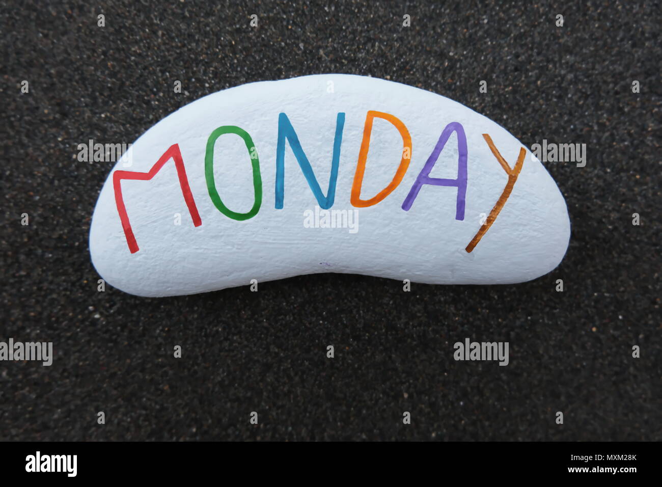 Monday, first day of the week carved and painted on a white stone over ...