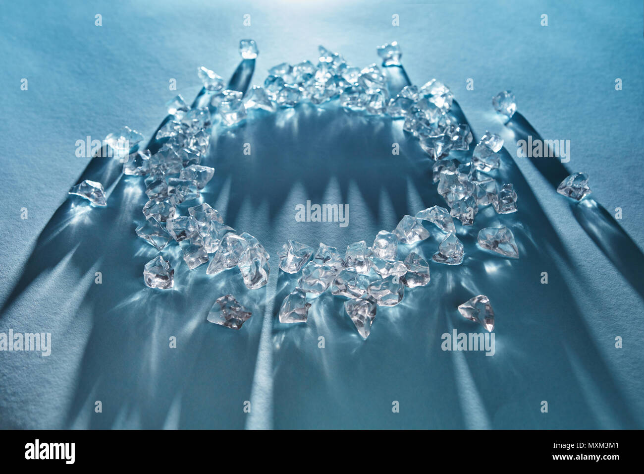 Shiny ice cubes in the form of a round frame on a blue background Stock ...