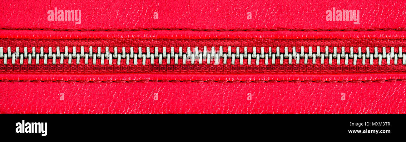 Zipper tightly closed binding together two layers of red fabric textile ...