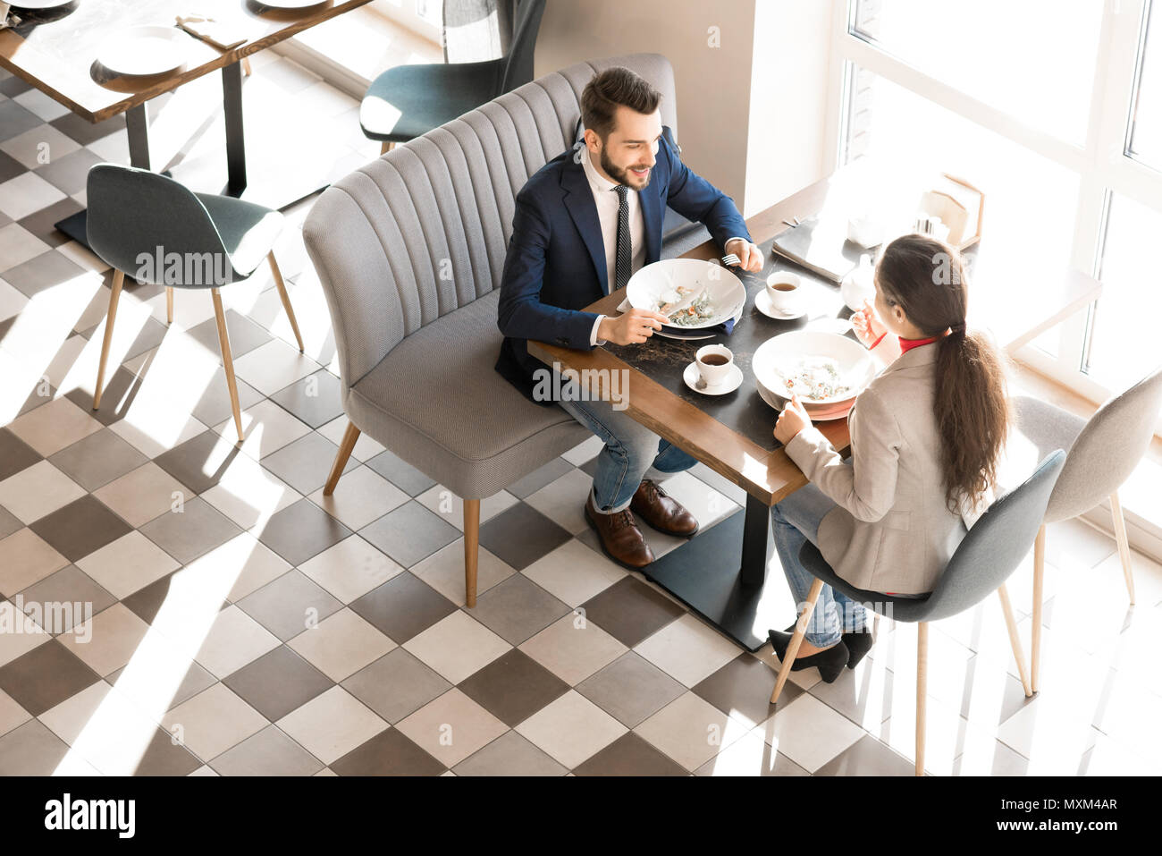 Positive colleagues enjoying lunch time in business cafe Stock Photo ...