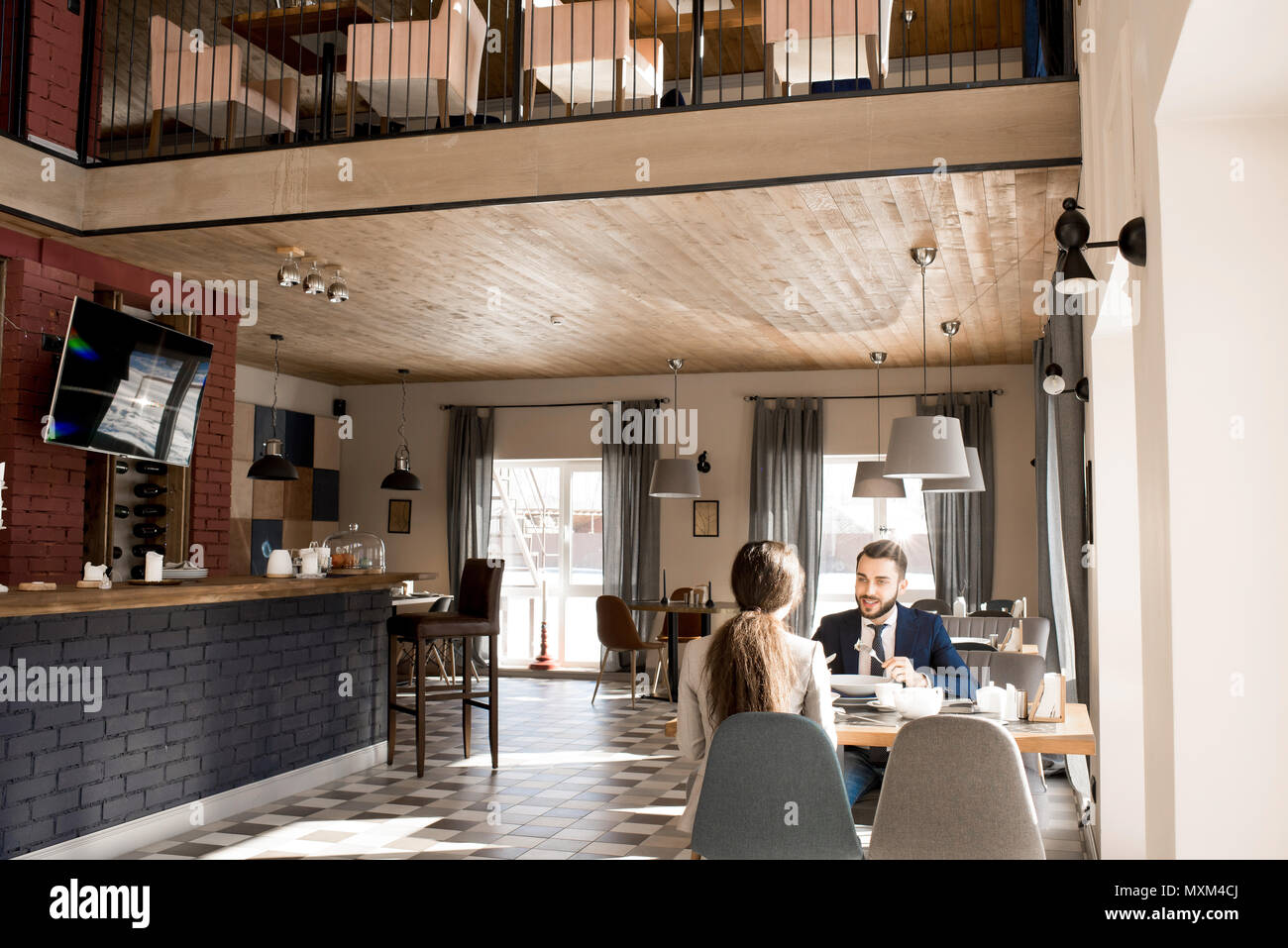 Positive business people discussing work over lunch Stock Photo - Alamy
