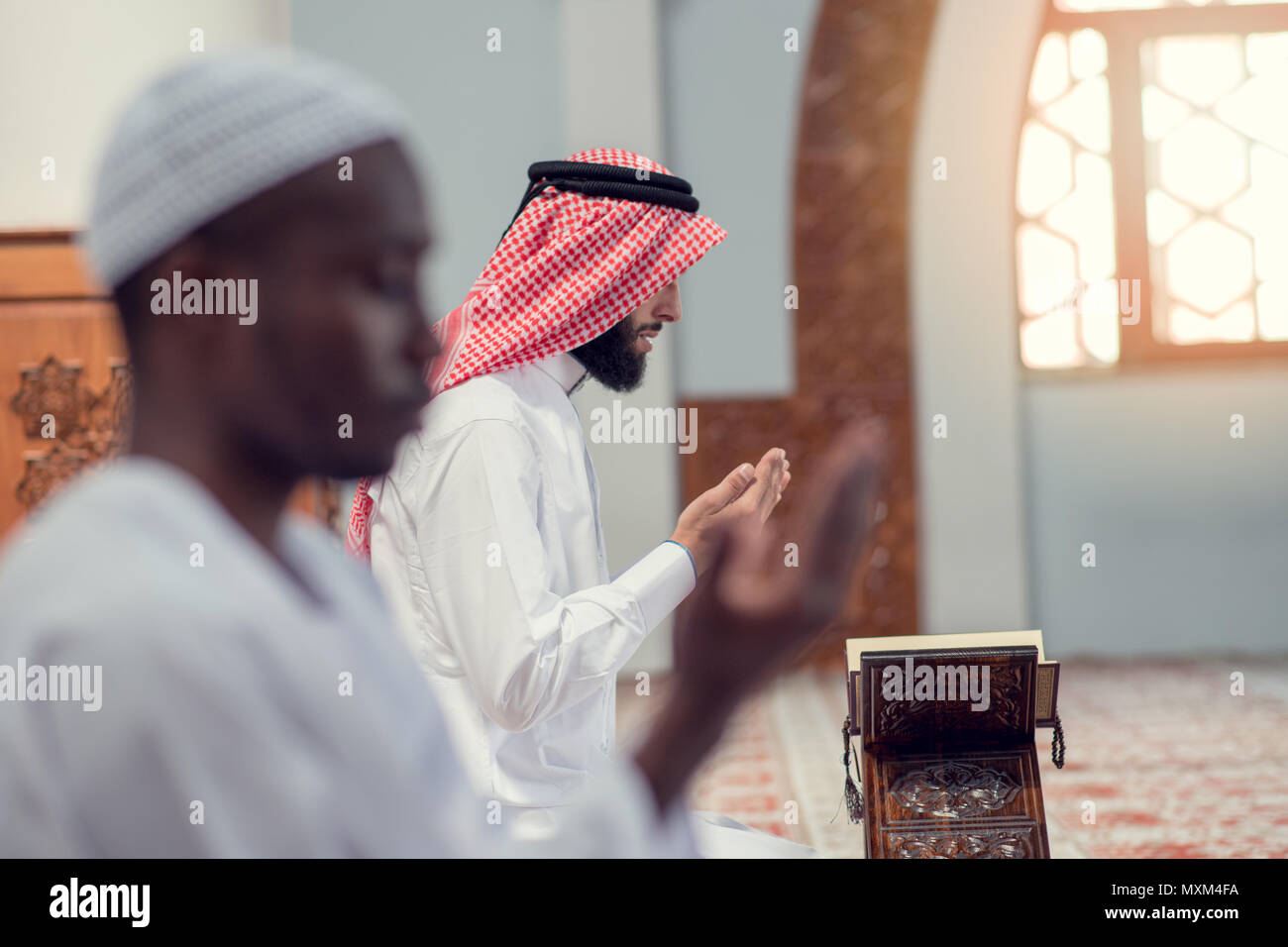 Two religious muslim man praying together inside the mosque Stock Photo ...