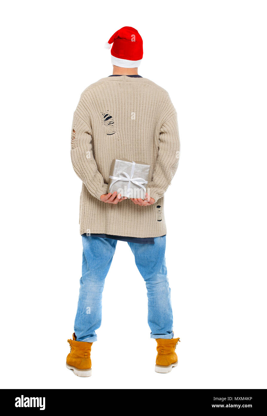 Back view of a man in a Christmas hat with a gift box. Rear view people ...