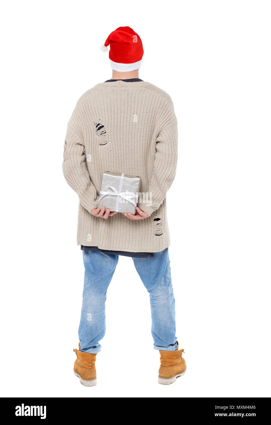 Back view of a man in a Christmas hat with a gift box. Rear view people ...