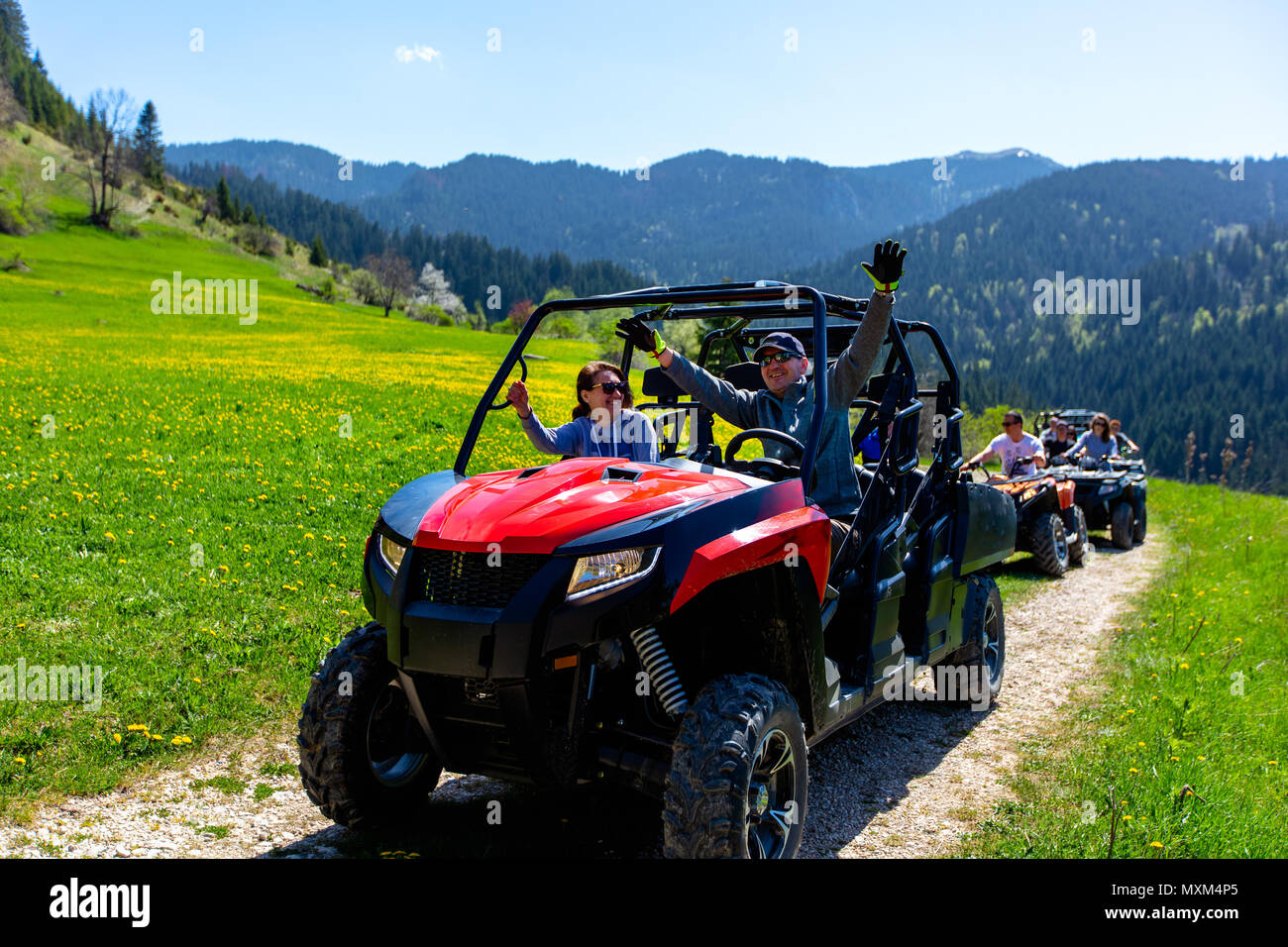 A tour group travels on ATVs and UTVs on the mountains Stock Photo - Alamy