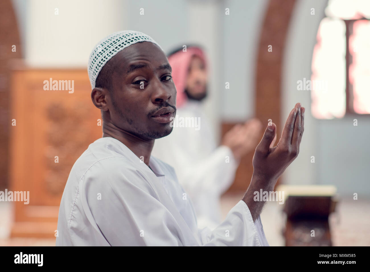 Two religious muslim man praying together inside the mosque Stock Photo ...