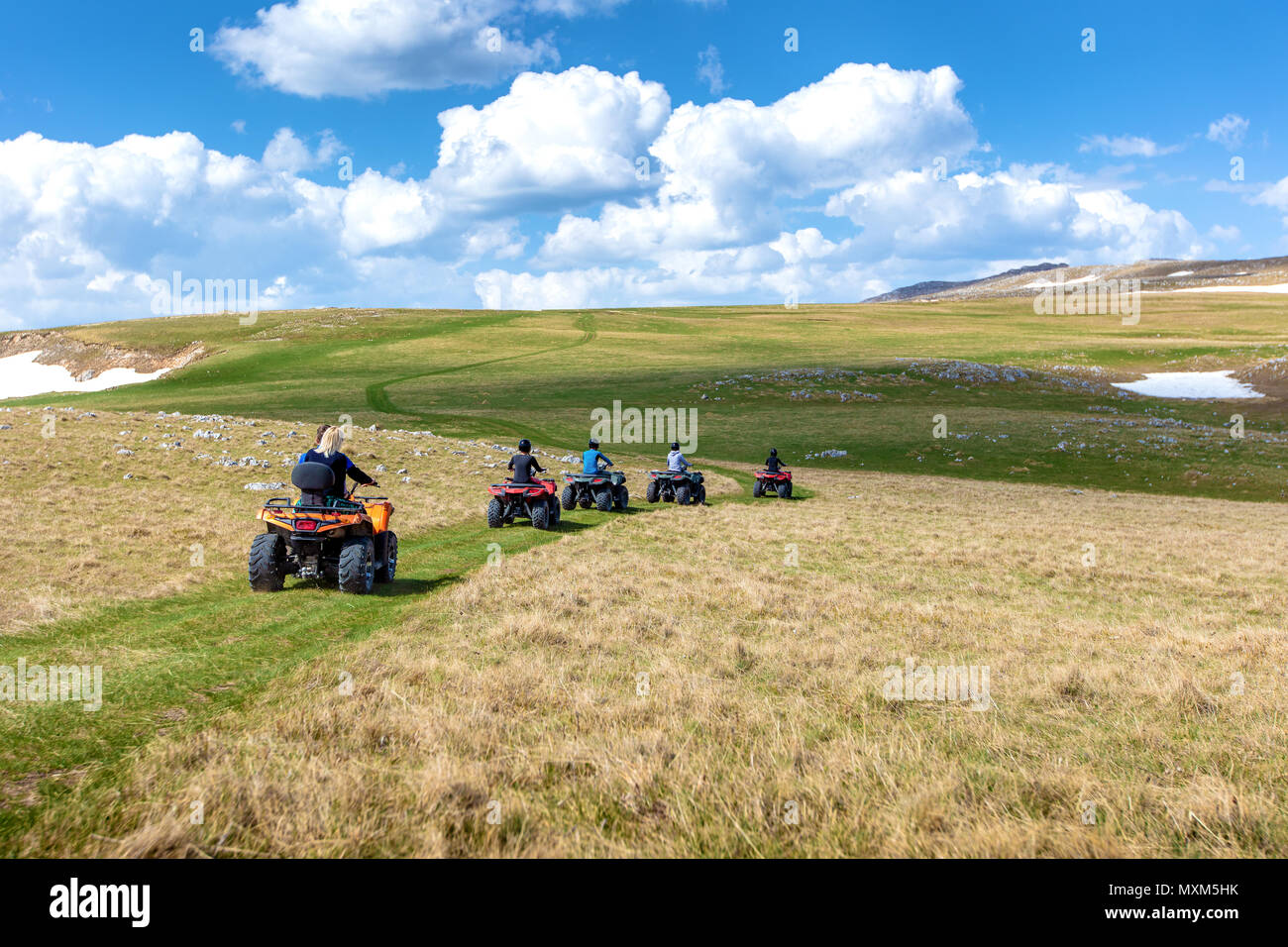 Friends driving off-road with quad bike or ATV and UTV vehicles Stock ...