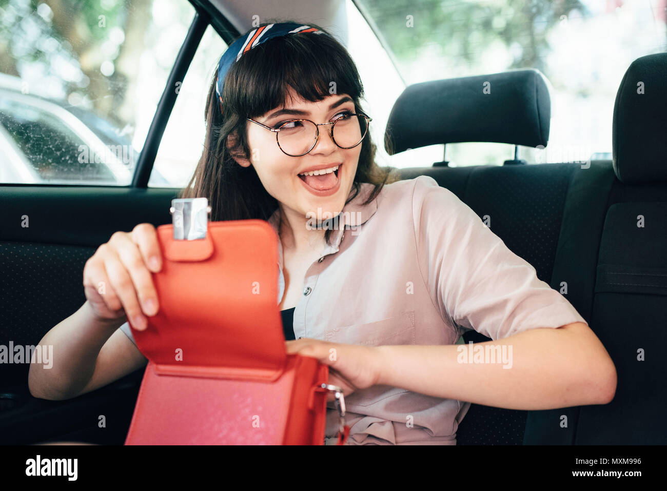 Young Pretty Teenage Girl Sitting On A Passenger Car Seat With A Small 4315