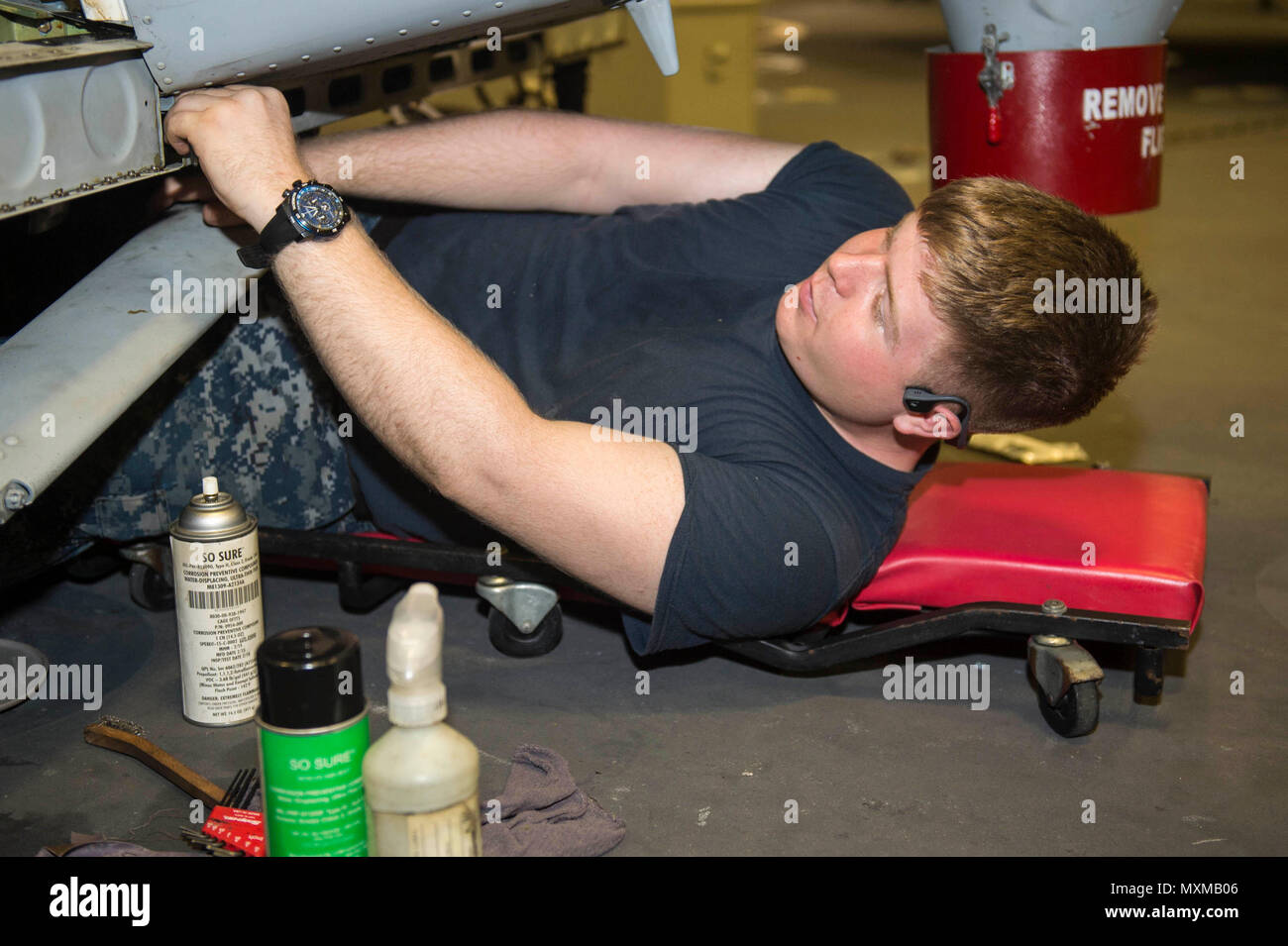 Petty Officer 3rd Class conducts preventive maintenance on an MQ-8B ...