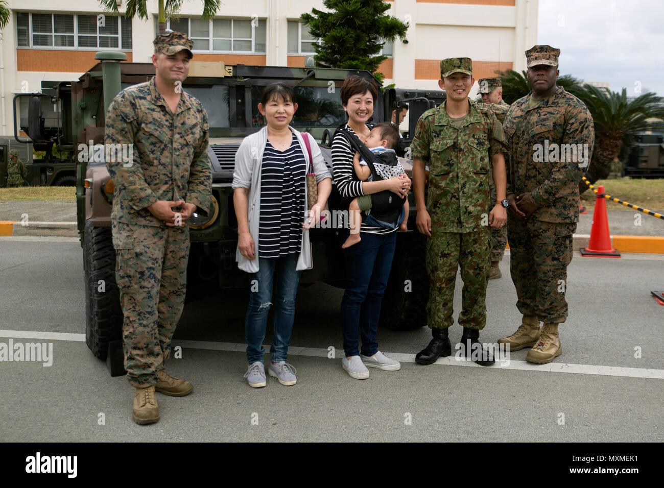 A family poses with Marines and a Japan Ground Self Defense Force ...