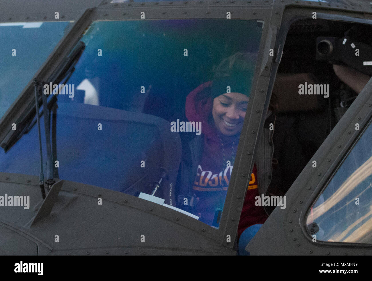 A football fan sits inside a U.S. Army Black Hawk from Bravo Company ...
