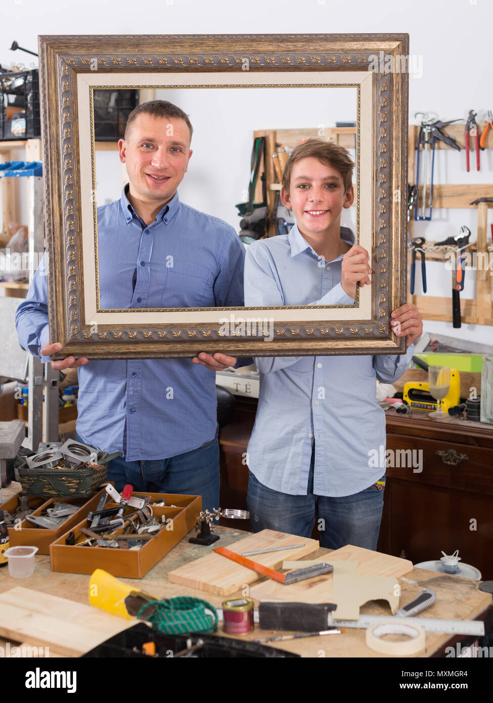 portrait of happy russian man and boy choosing tight wooden bar in ...