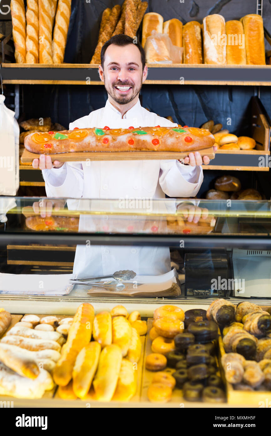 Professional seller is offering fresh festive cake in bakery Stock ...