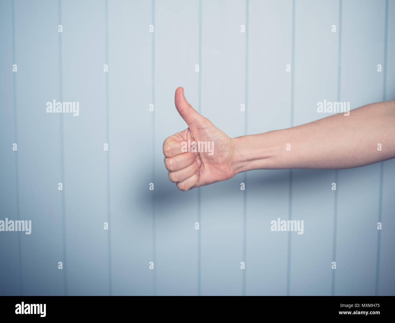 A young female hand is displaying thumbs up gesture Stock Photo - Alamy