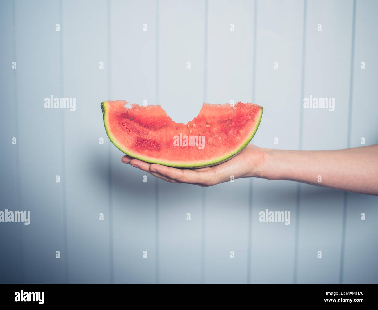 A female hand with a slice of watermelon Stock Photo - Alamy