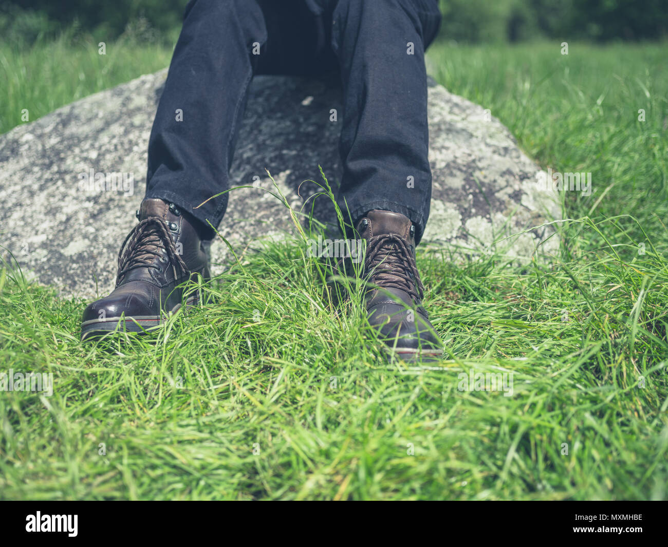 Feet man sitting on rock hi-res stock photography and images - Alamy