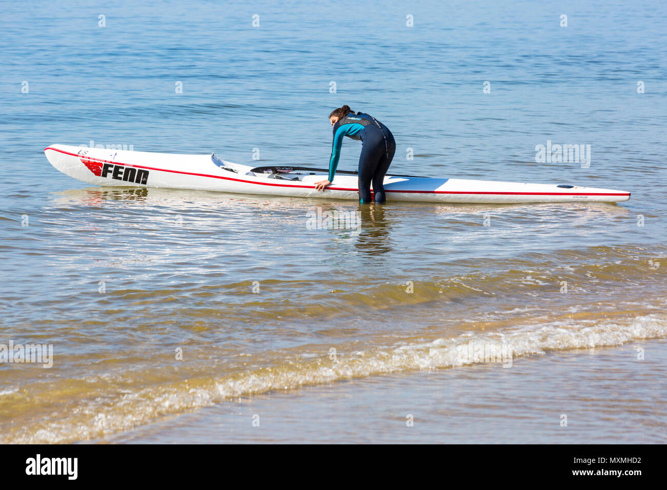 Young woman getting in a surfski hi-res stock photography and images ...