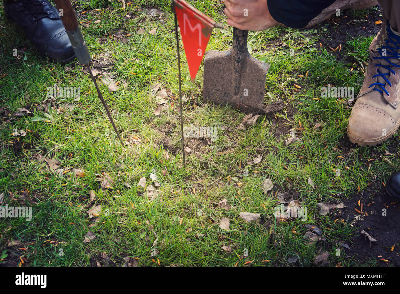 miner digs a mine. Demining of the territory. the guys digs a mine on a ...