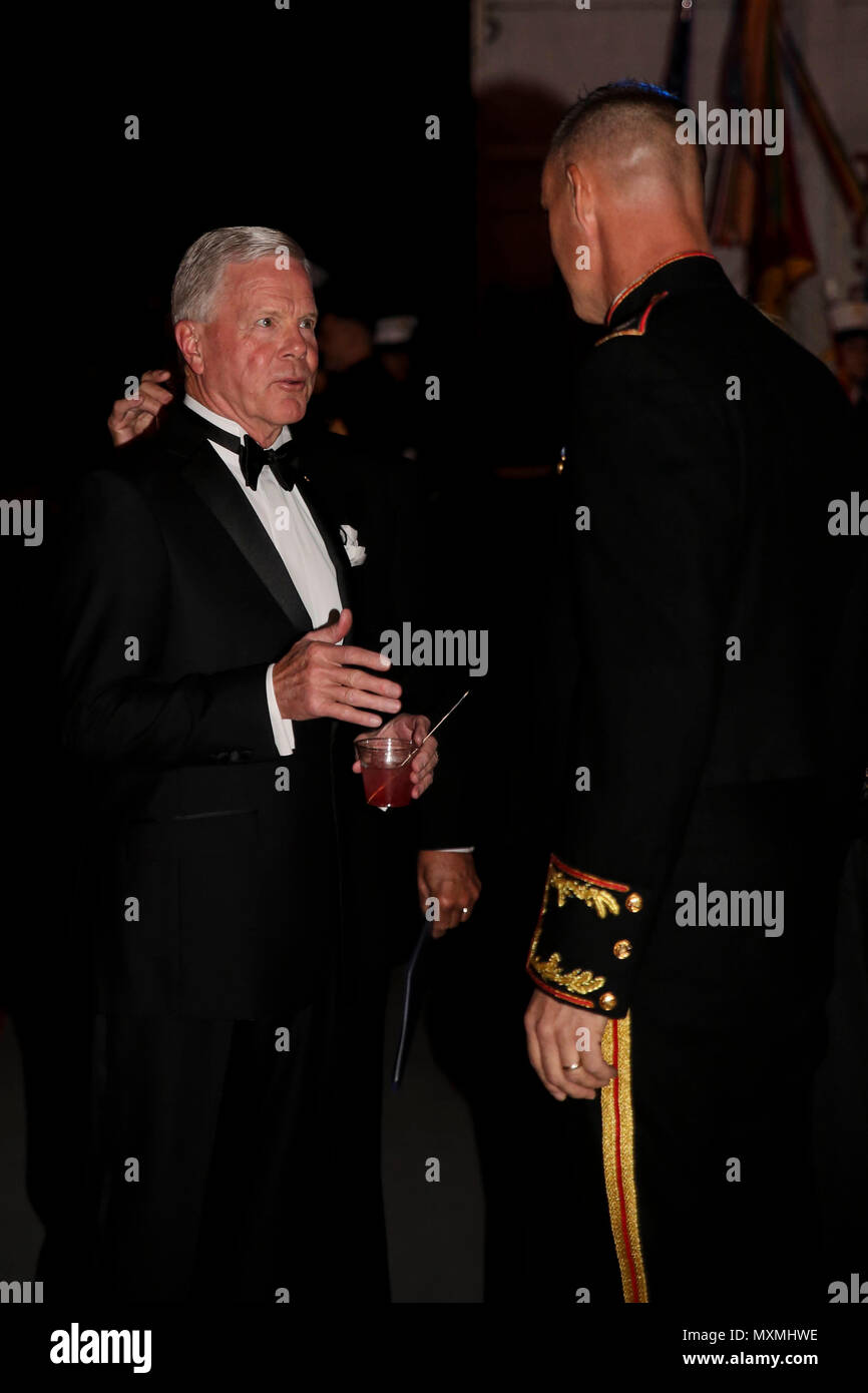 Col. Robert Cooper (right) greets retired Gen. James F. Amos (left) at ...