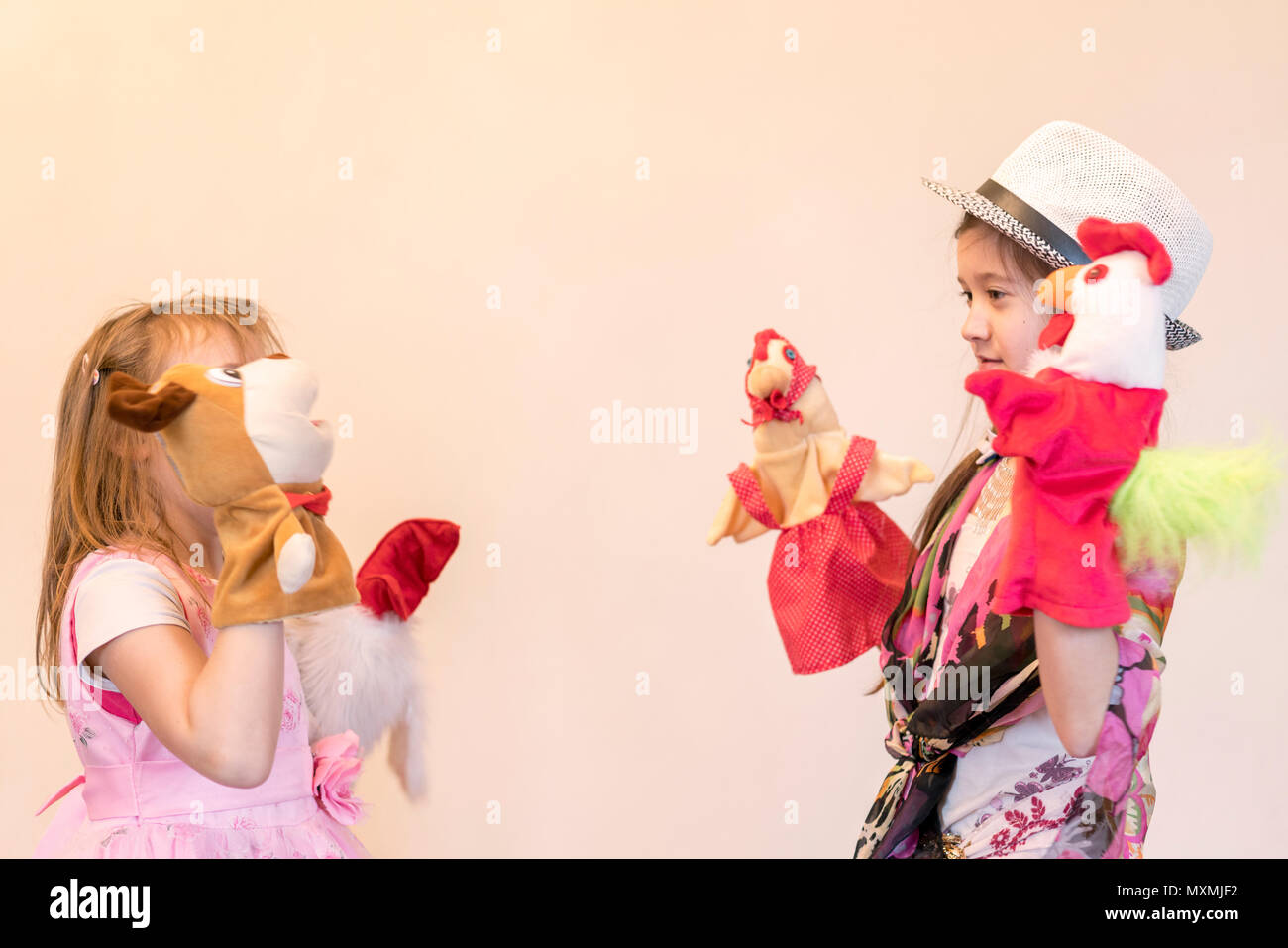 Two girls play in the puppet theater Against a light background Stock ...