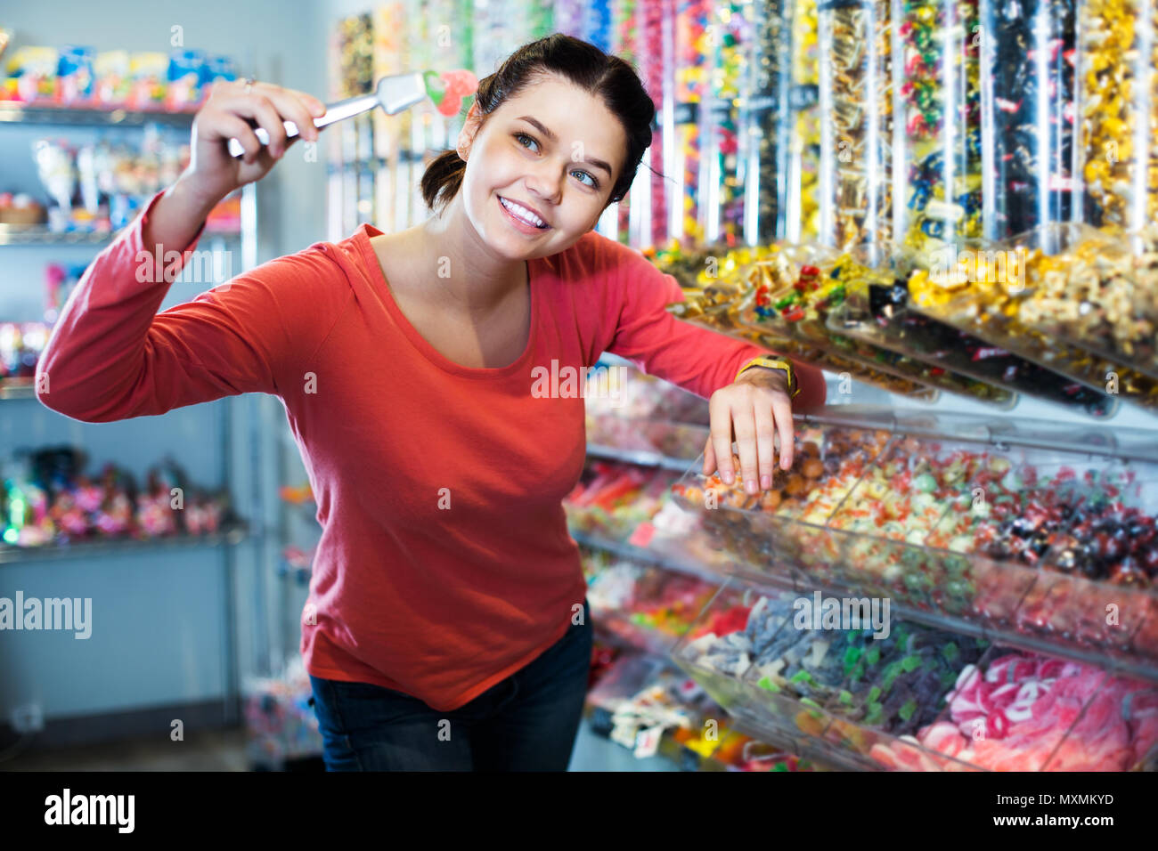 Young attractive woman with candies at sweets shop Stock Photo - Alamy