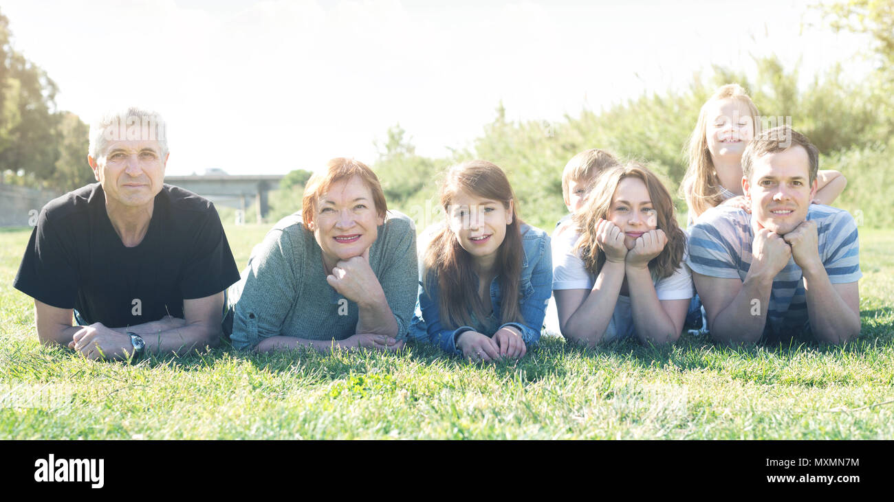 Smiling people of different ages taking photos on the lawn Stock Photo ...