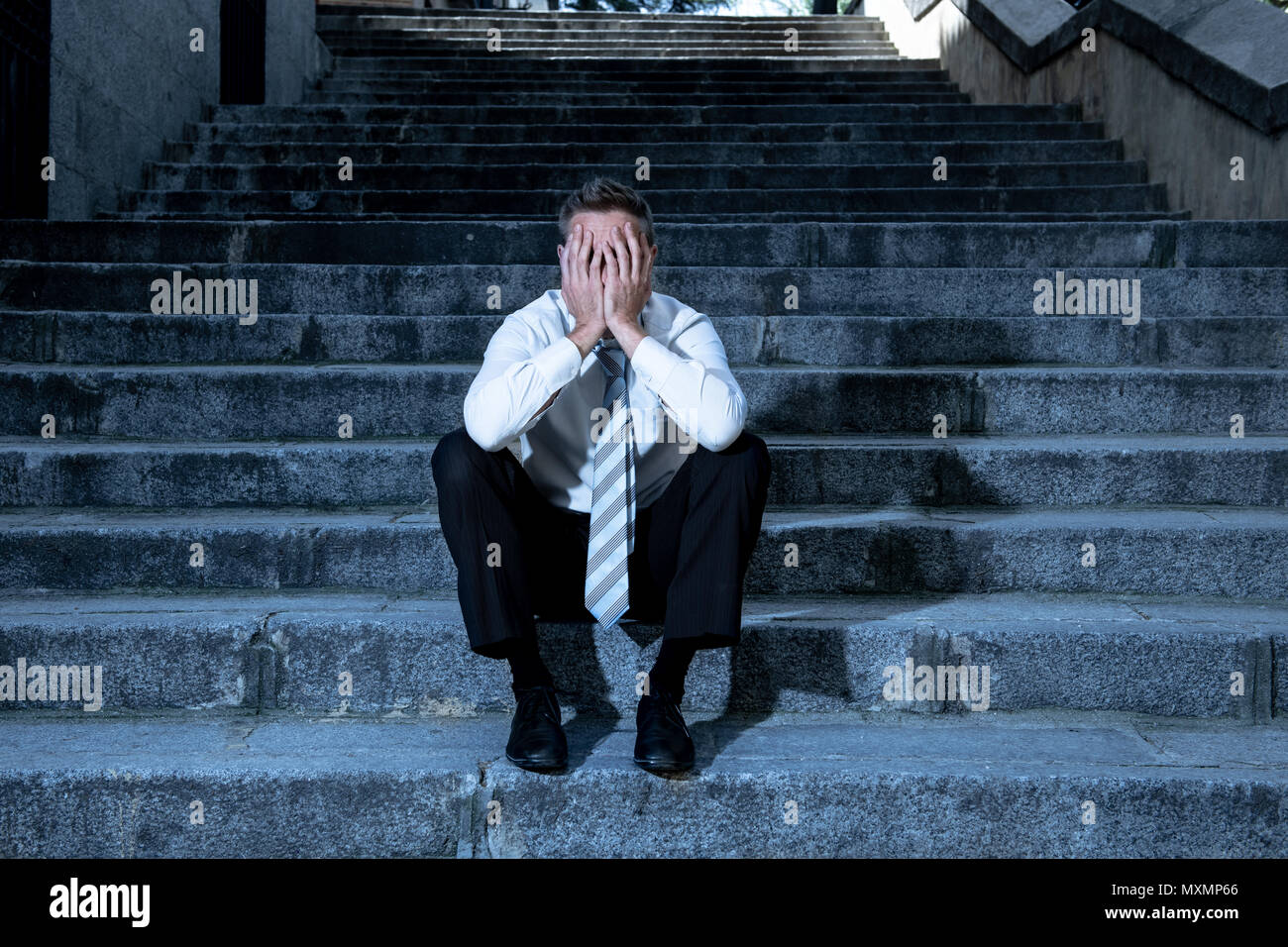 young business man crying abandoned lost in depression sitting on the ...