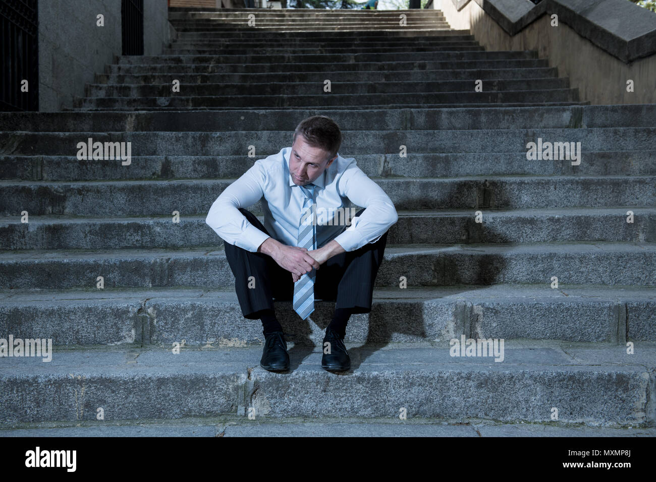 young business man crying abandoned lost in depression sitting on the ...