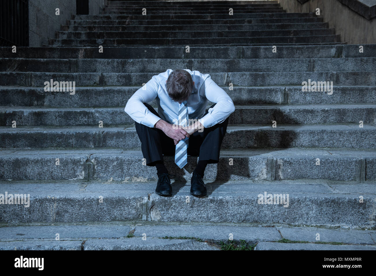 young business man crying abandoned lost in depression sitting on the ...