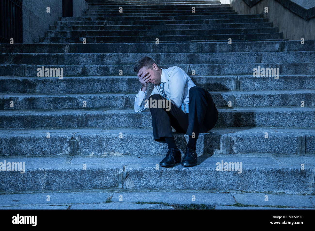 young business man crying abandoned lost in depression sitting on the ...