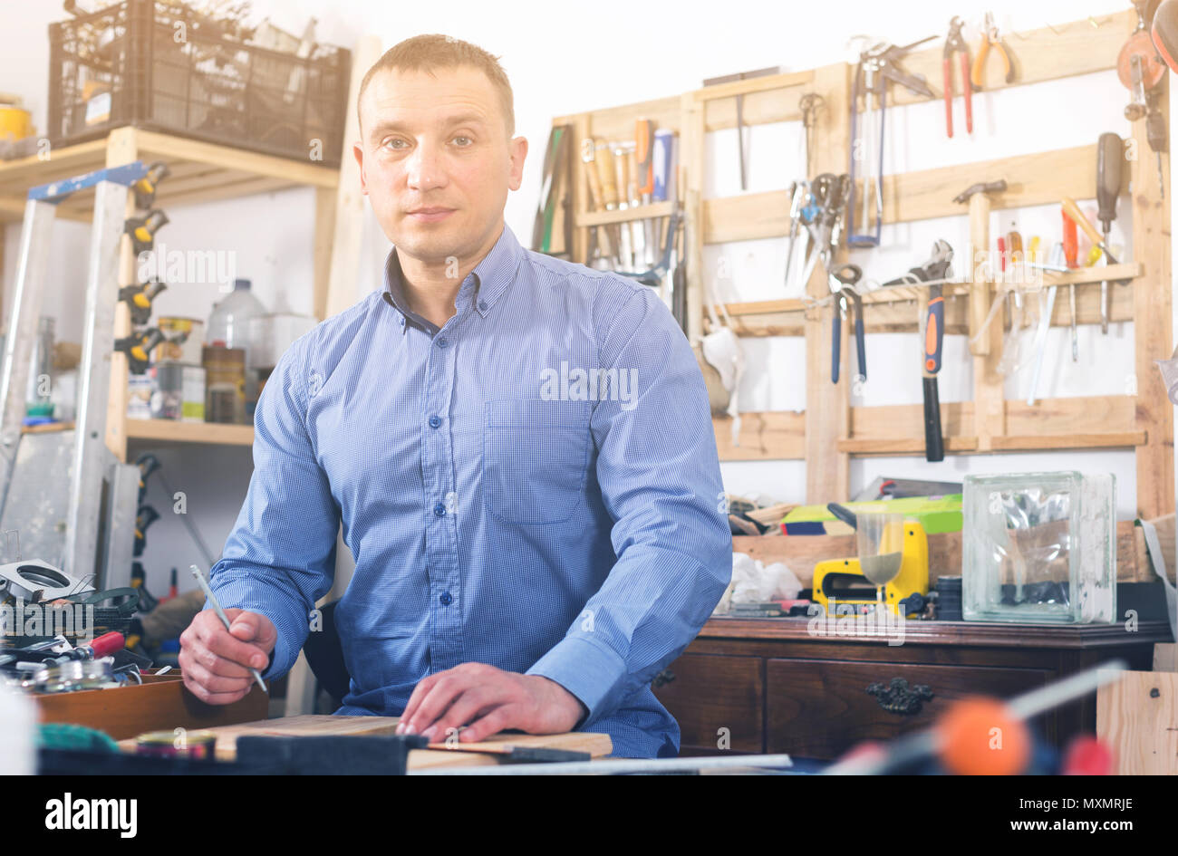 happy young russian male carpenter working wood plank at workshop Stock ...