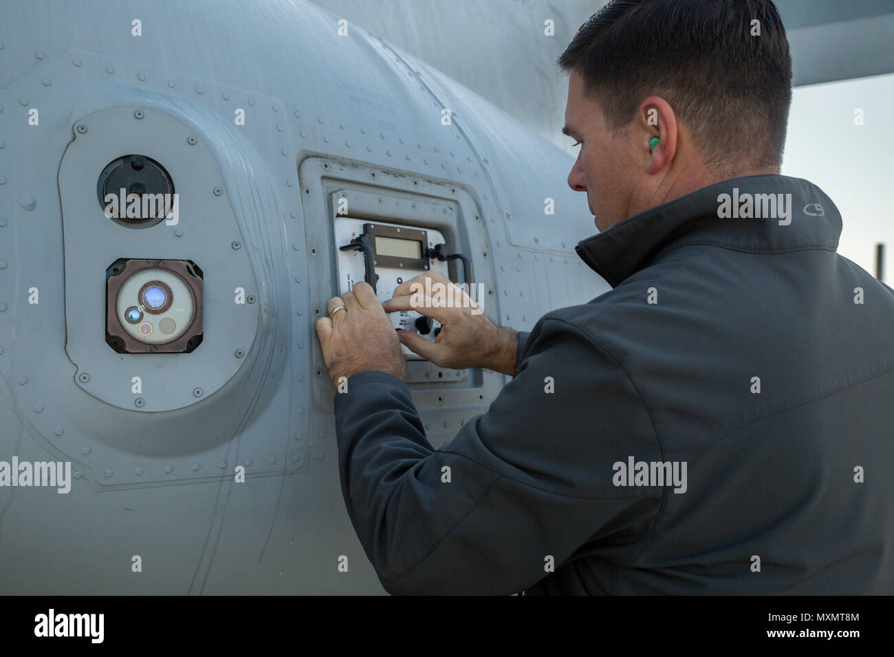Jon Ayres attaches a countermeasure dispensing simulator to the side of ...