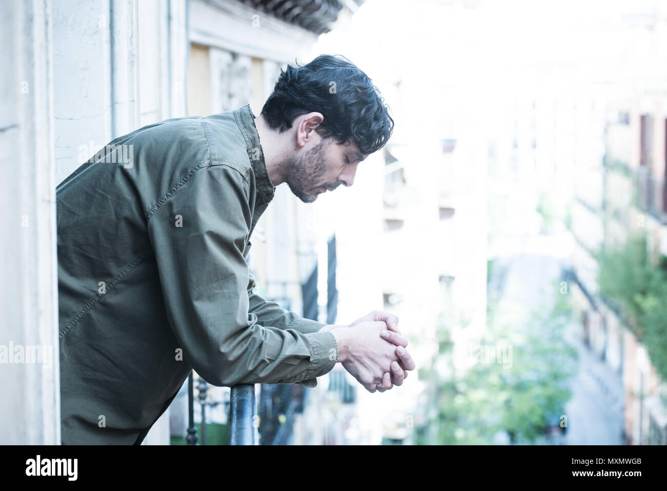 close up portrait of sad and depressed man looking out the window on a ...