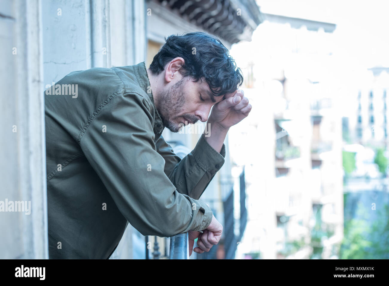 close up portrait of sad and depressed man looking out the window on a ...