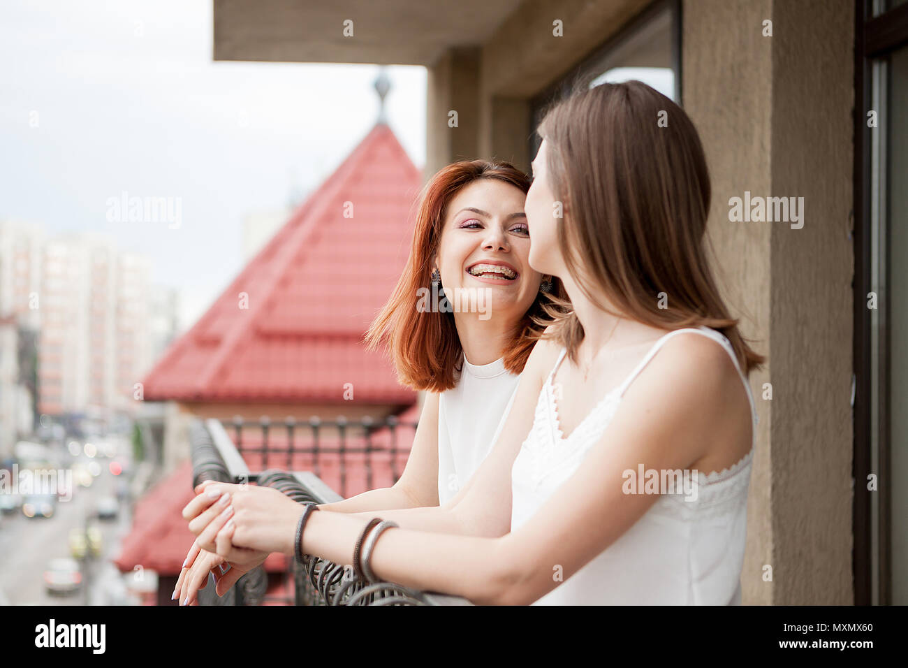 Two people balcony talking hi-res stock photography and images - Alamy