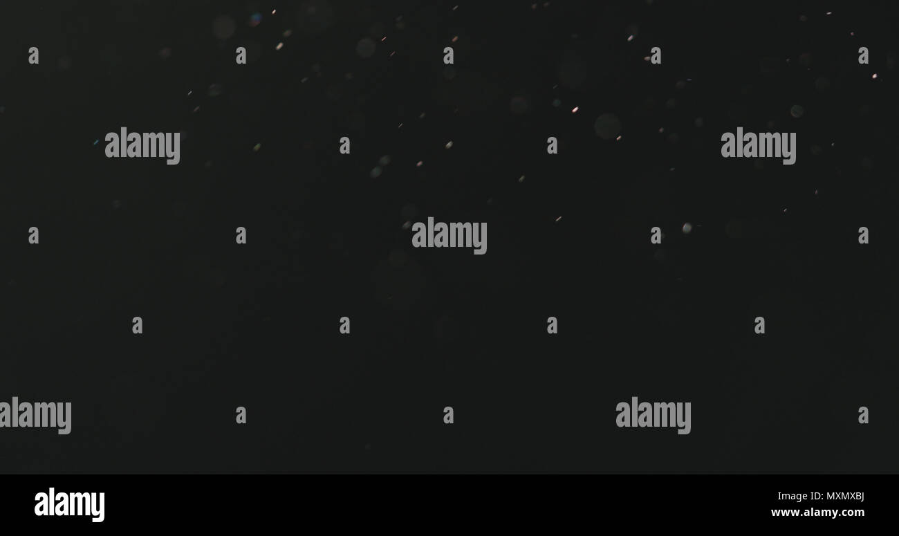 dust particles floating over black background with motion blur Stock ...