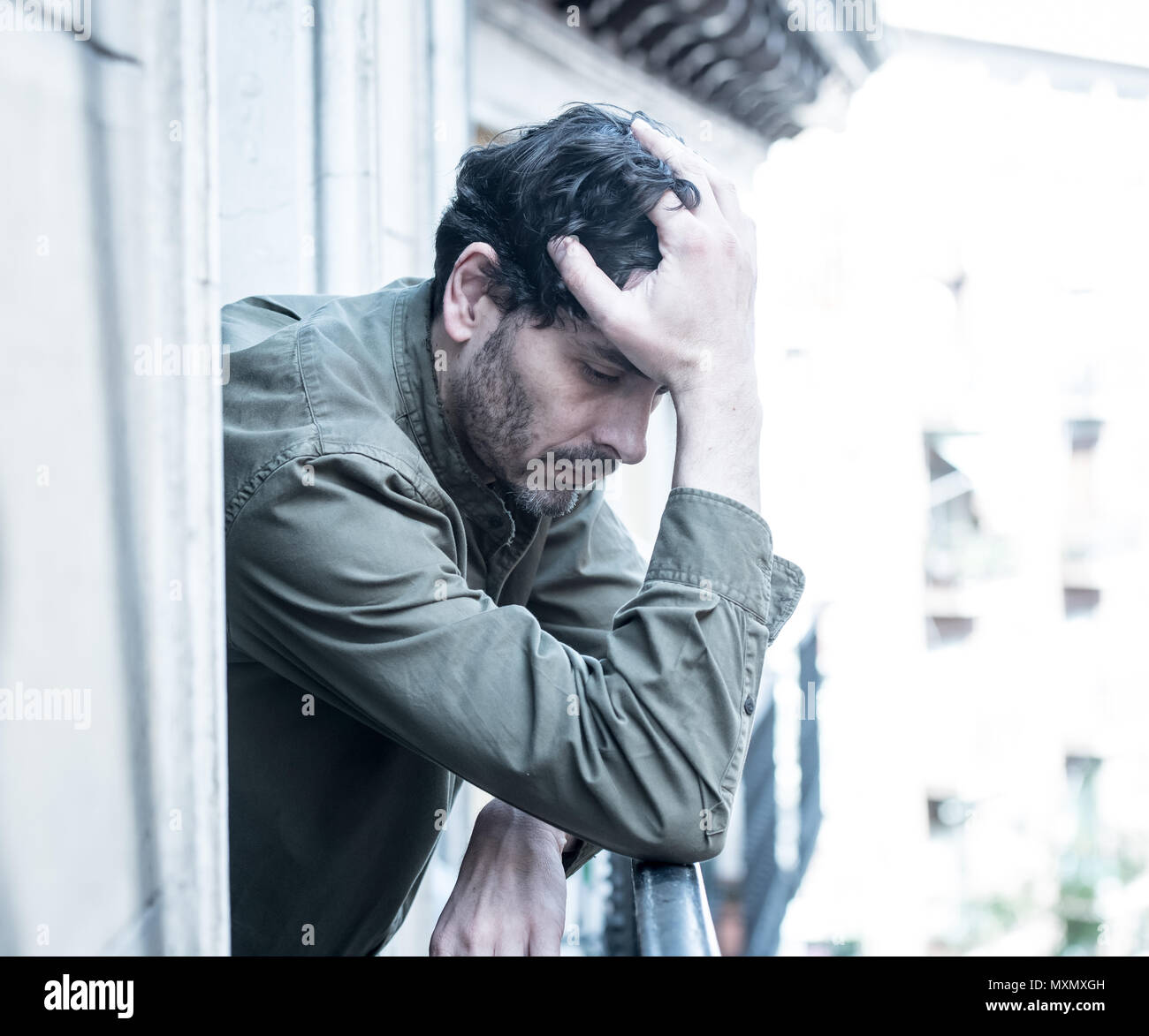 close up portrait of sad and depressed man looking out the window on a ...