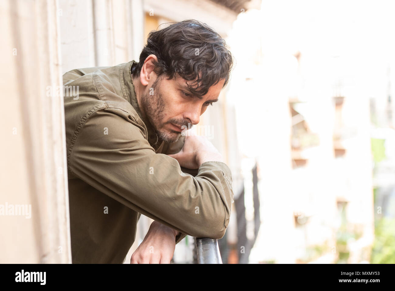 close up portrait of sad and depressed man looking out the window on a ...