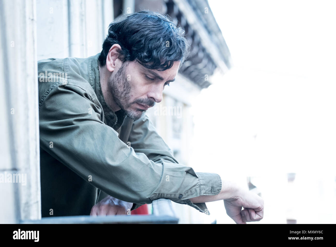 close up portrait of sad and depressed man looking out the window on a ...