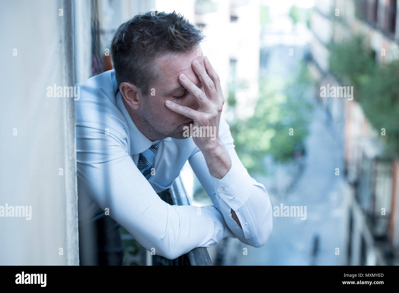 close up portrait of sad and depressed man looking out the window on a ...