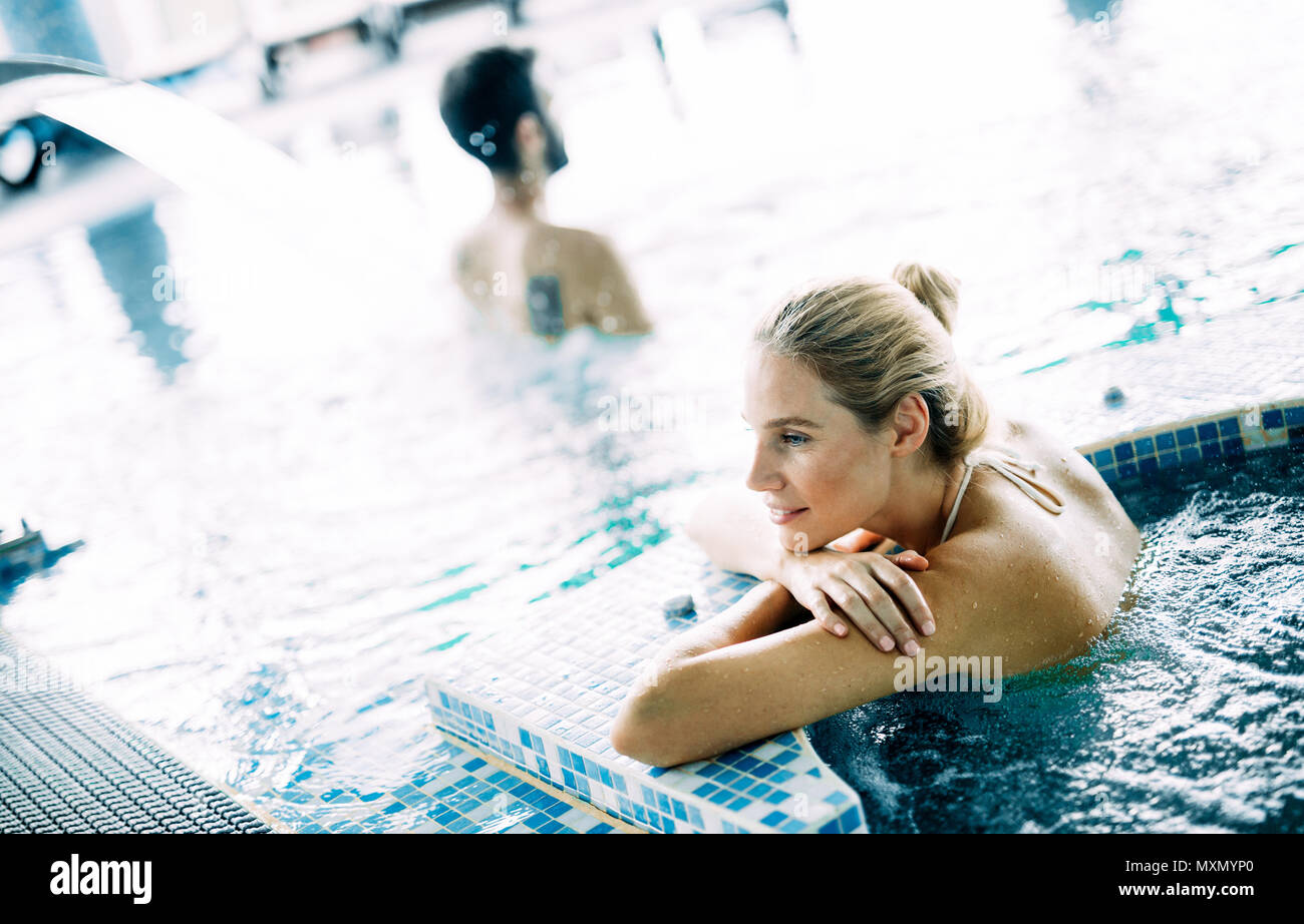Portrait young woman relaxing swimming pool hi-res stock photography ...
