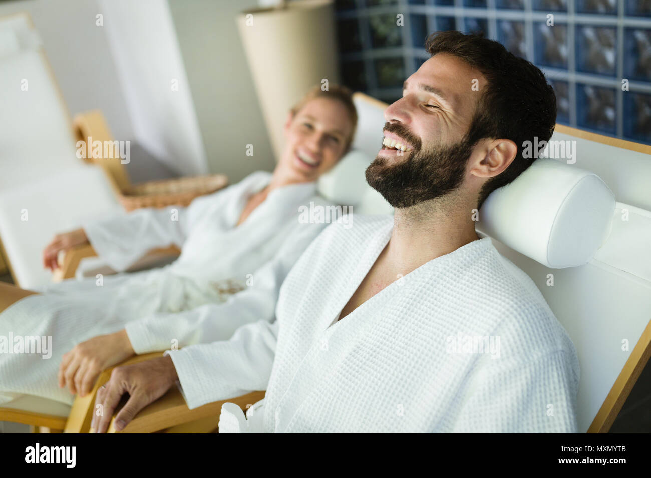 Attractive happy couple relaxing in spa center Stock Photo - Alamy