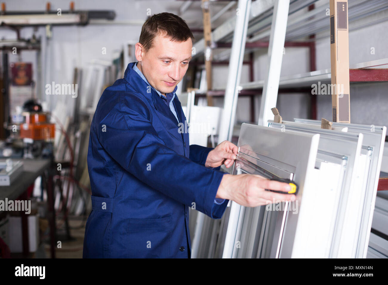 Production young worker in coverall with different PVC windows and ...