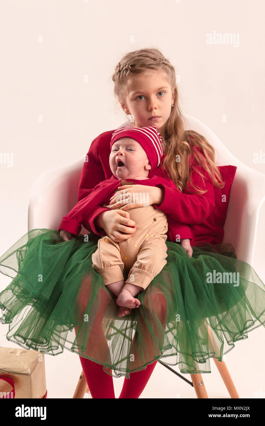 Happy little teen girl holding his newborn baby little sister. Family ...