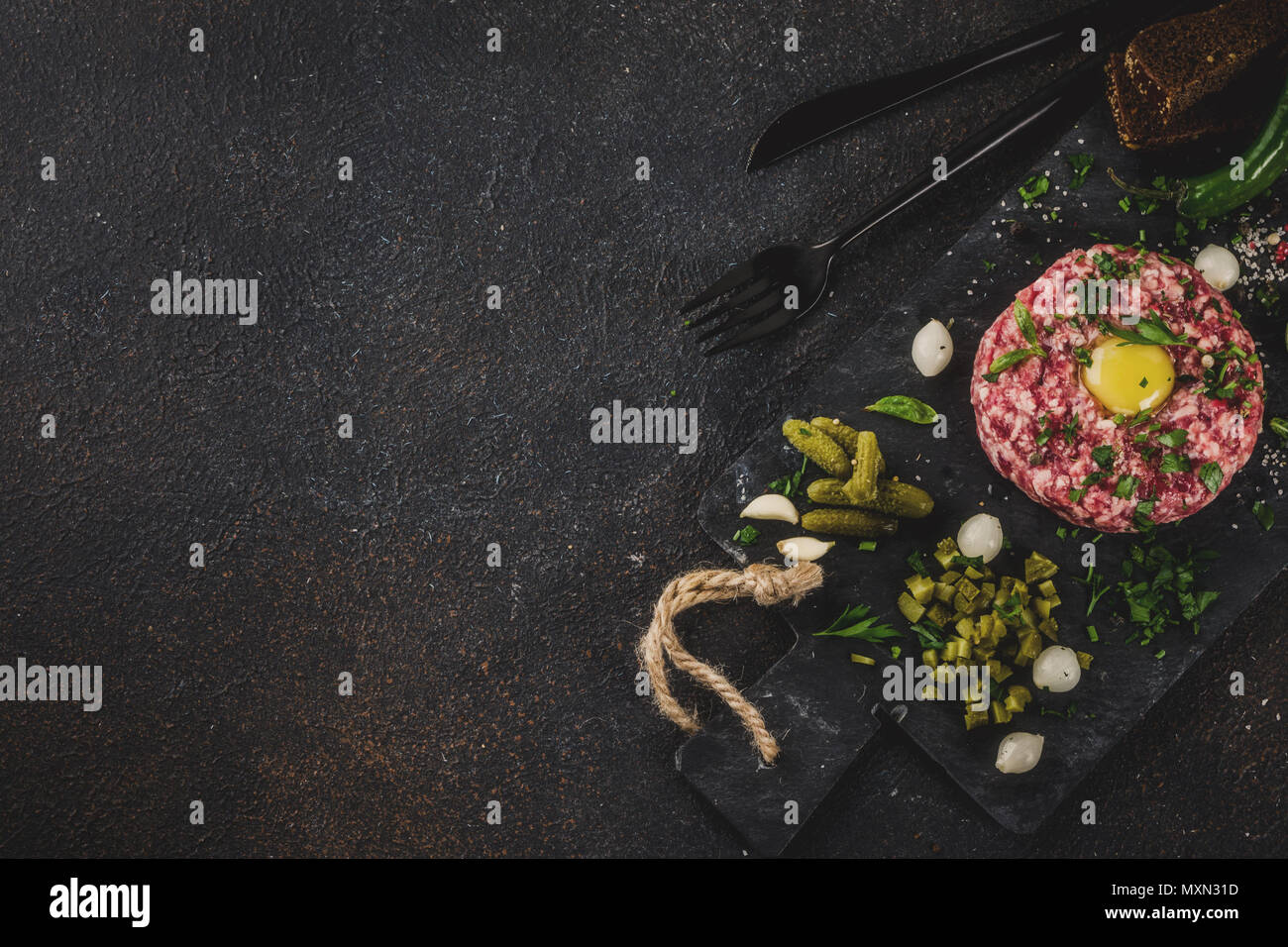 French cuisine, beef steak tartare with raw quail egg yolk, pickled ...