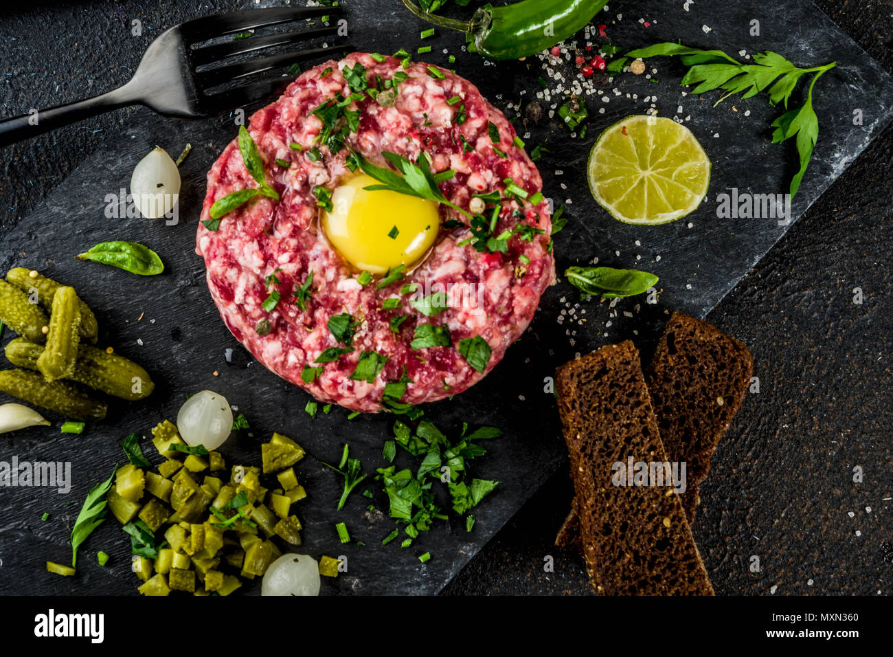 French cuisine, beef steak tartare with raw quail egg yolk, pickled ...