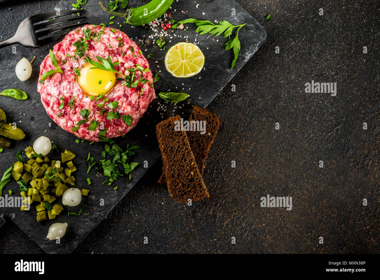French cuisine, beef steak tartare with raw quail egg yolk, pickled ...