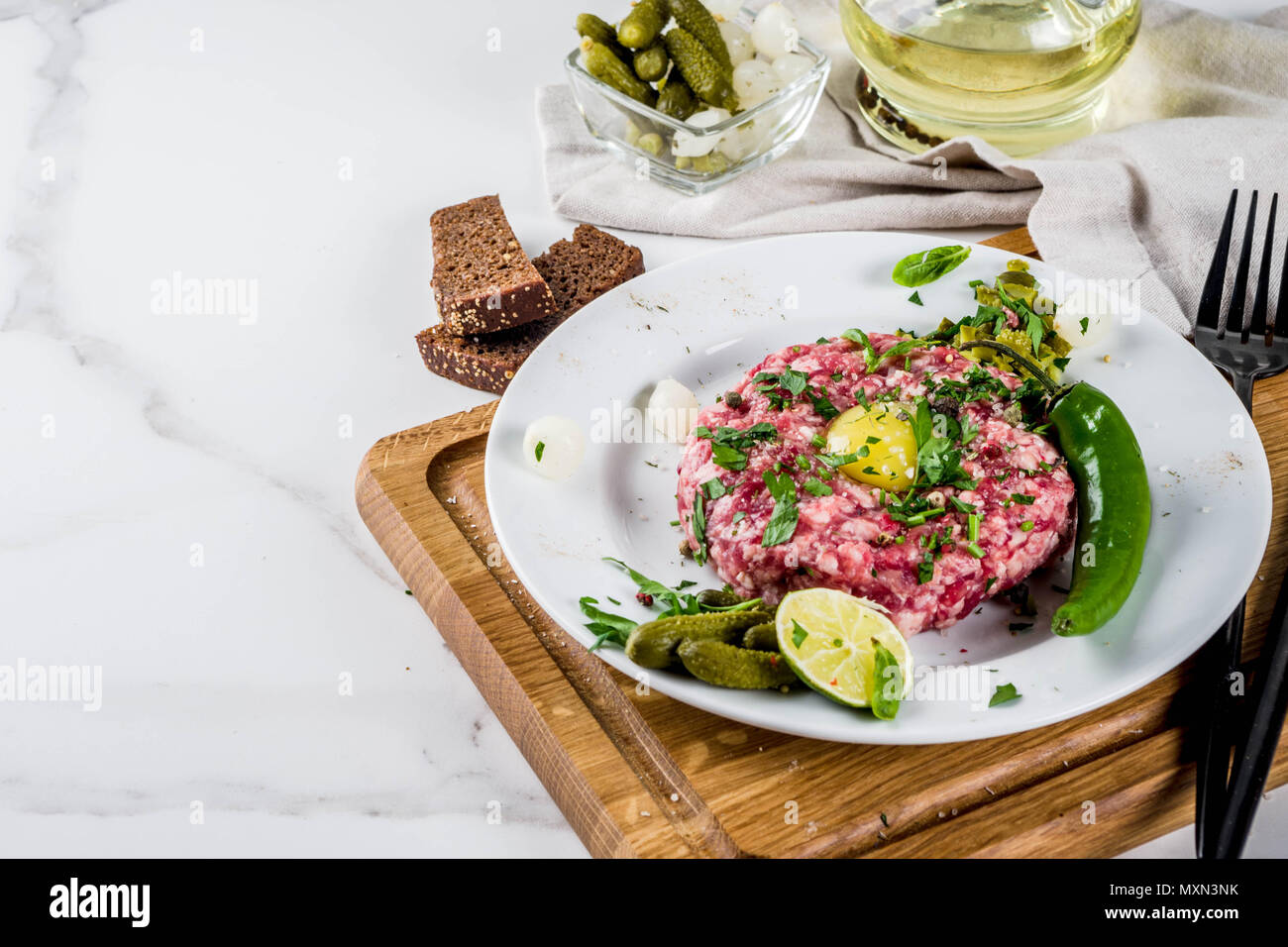 French cuisine, beef steak tartare with raw quail egg yolk, pickled ...
